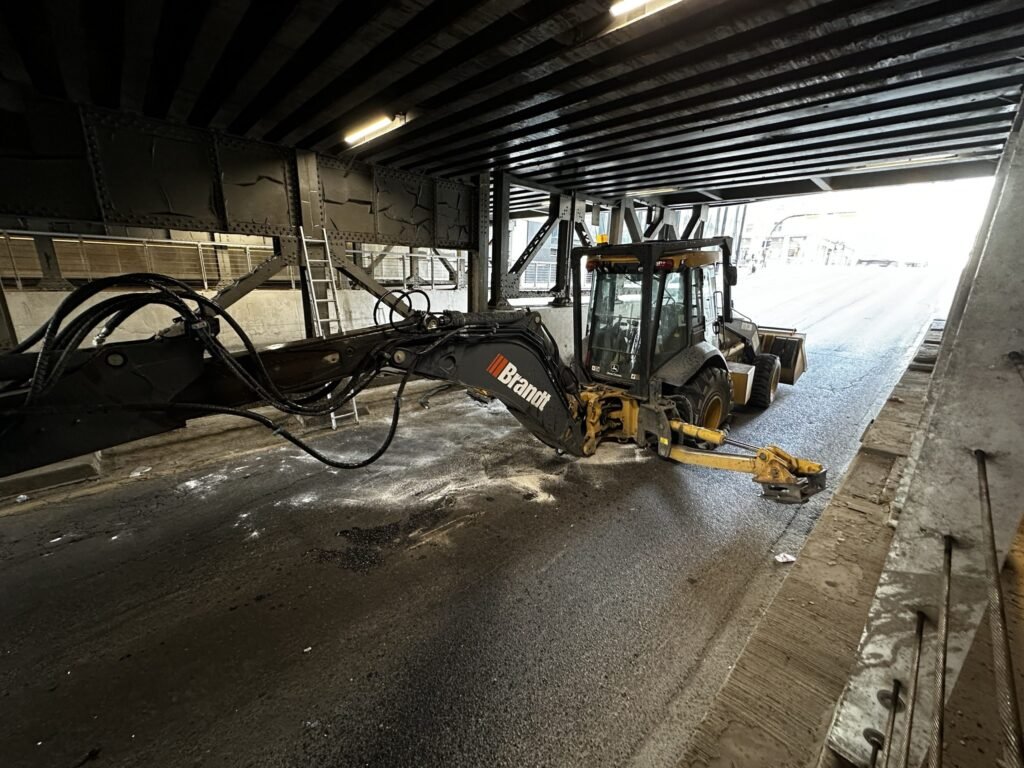 Road reopens after backhoe gets stuck under bridge in downtown Calgary ...